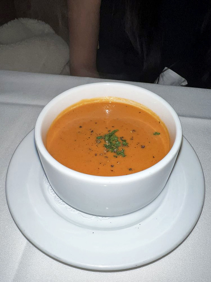 This isn't just tomato bisque &ndash; it's a velvety orange pool of comfort that makes you wonder why anyone bothers with canned soup.