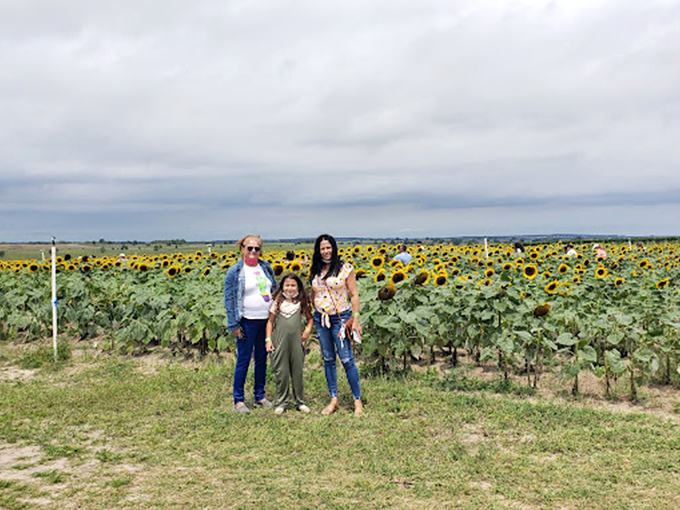 Three generations of smiles with sunflowers as the backdrop&mdash;the farm's ability to create memory-making moments on full display.