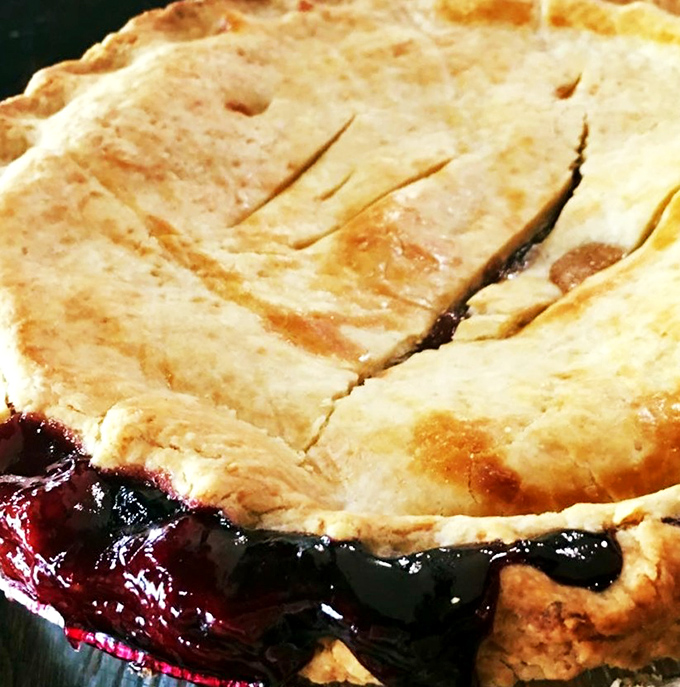 This berry pie isn't just leaking&mdash;it's showing off. The crimson filling escaping its buttery prison is nature's way of saying "eat me now."