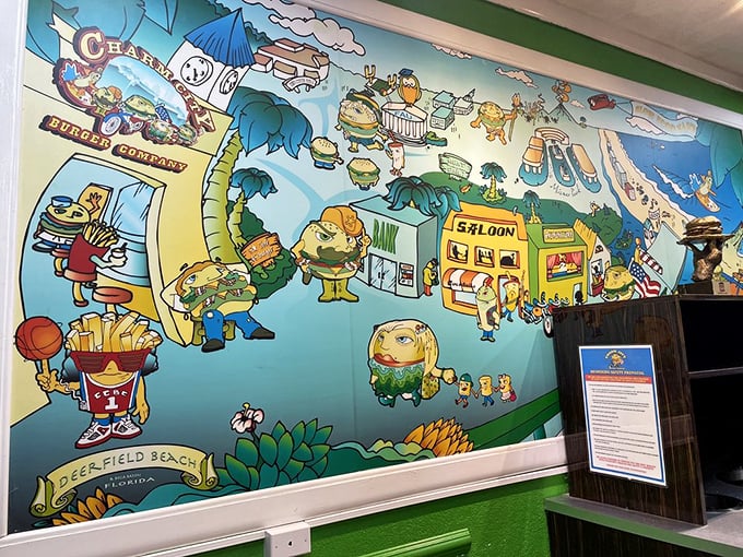 The whimsical wall mural tells Charm City's story through cartoon burgers living their best lives in Deerfield Beach.