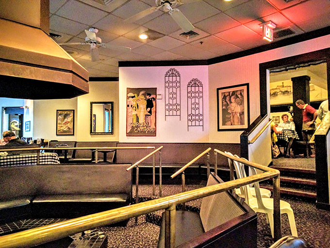 The multi-level dining room with its vintage posters creates an atmosphere that says, "Relax, we've been doing this right for decades." No trendy redesigns needed here.