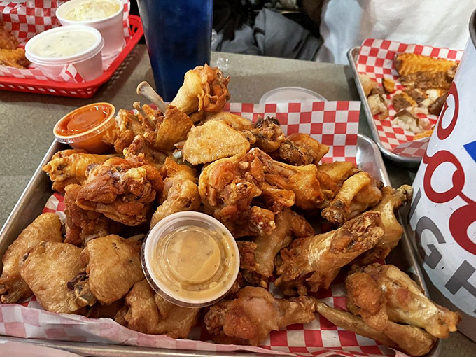 A tray of wings that could make angels weep, served with dipping sauces that deserve their own fan club.