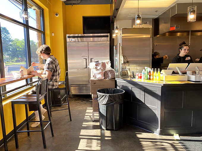 The counter-dining experience: sunlight, solitude, and serious chicken. Sometimes the best dining companion is just the anticipation of your first bite.