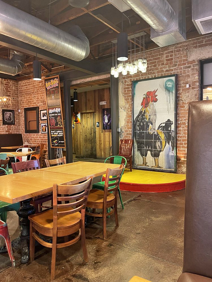 Exposed brick, industrial pipes, and that rooster artwork watching over diners like a proud parent at a recital.