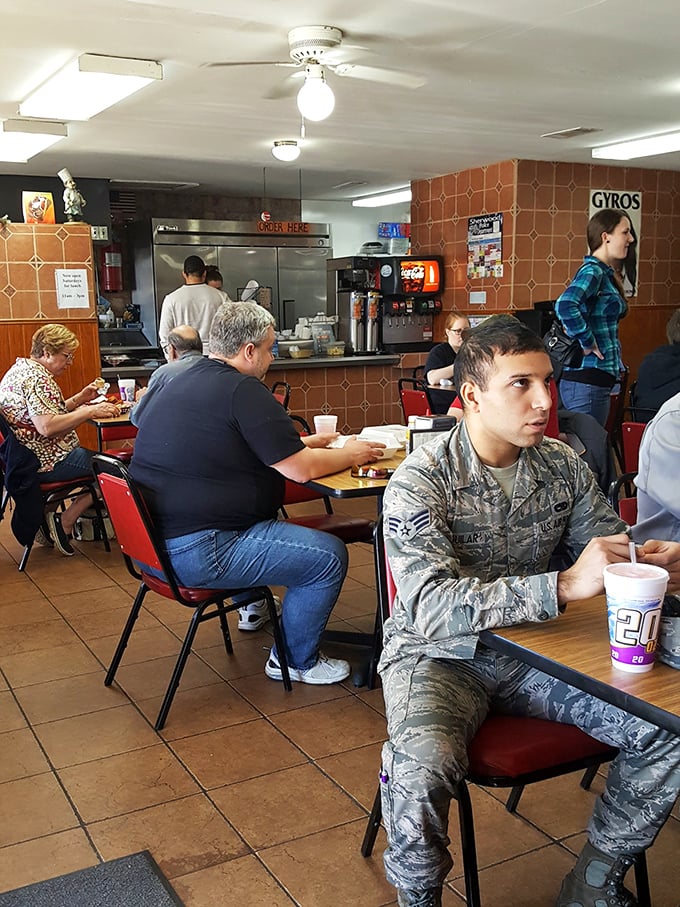 A cross-section of humanity united by one thing: the pursuit of perfect gyros. Even military personnel stand at attention here.