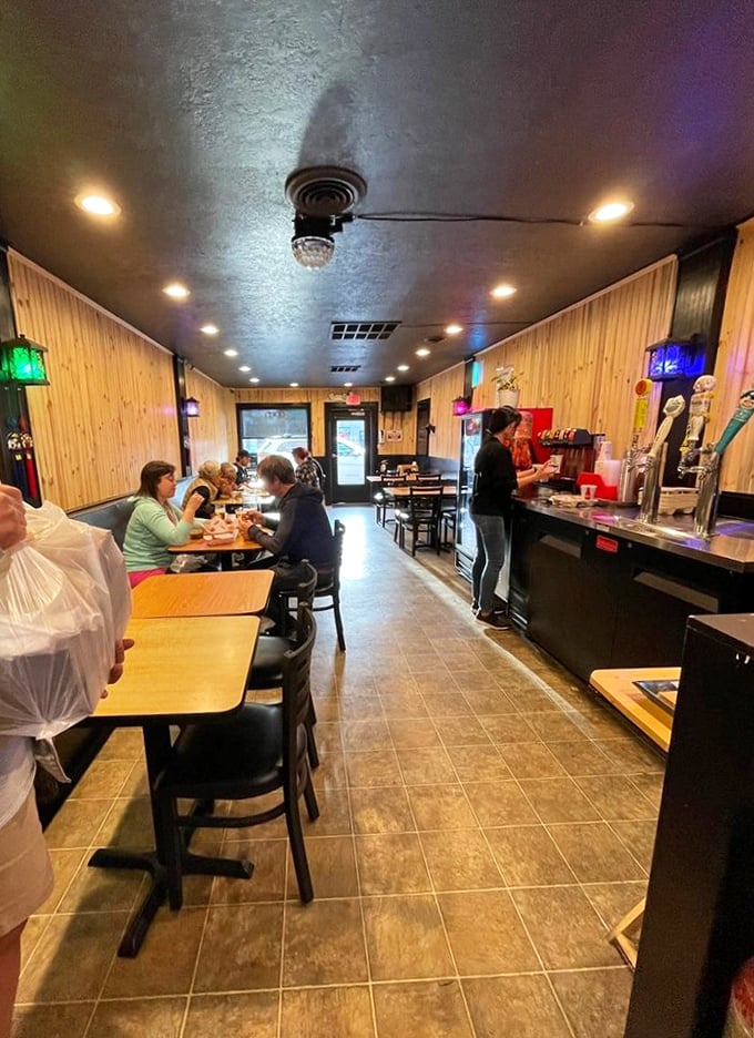 The narrow, wood-lined dining room feels like a secret club where the password is "crispy" and everyone's a VIP.