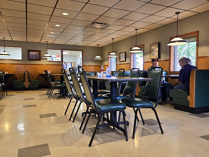 The dining room speaks volumes with its simplicity&mdash;green chairs, wood paneling, and pendant lights creating the stage where food memories are made.