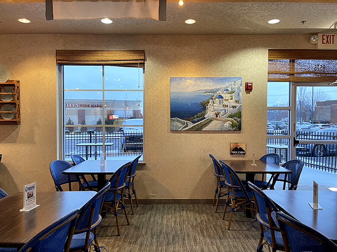 Windows flood the space with natural light, while Santorini blue chairs transport you from Kansas to the Aegean.