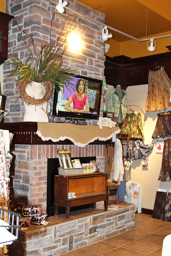 Even the stone fireplace gets the quilting treatment, creating a cozy corner where craft demonstrations and impromptu fabric consultations unfold.
