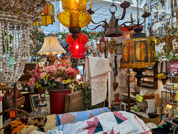 A textile wonderland where vintage quilts and lamplight create the coziest corner in Pennsylvania. That red lamp has illuminated countless bedtime stories.