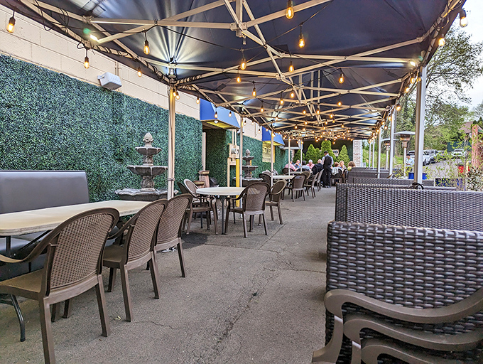 Diners gather around a wooden table sharing not just food but conversation. The brick and wood backdrop sets the stage for cultural and culinary connections.