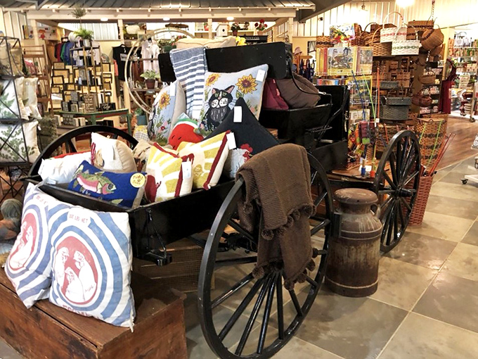 An antique buggy repurposed as a display &ndash; because nothing says "charming country store" quite like farm equipment filled with decorative pillows.