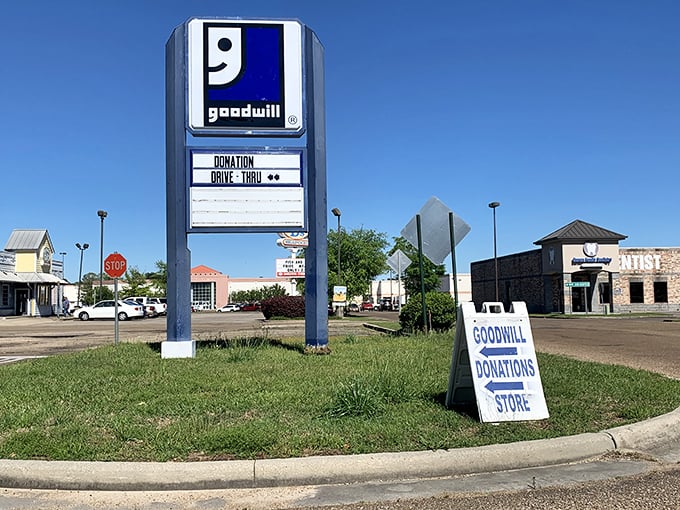 The Goodwill sign stands tall against the blue sky, a beacon for bargain hunters and sustainability champions alike.