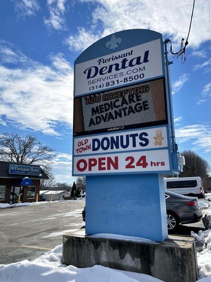 The roadside sign stands as a lighthouse for the donut-deprived, guiding hungry travelers to 24-hour salvation in Florissant.