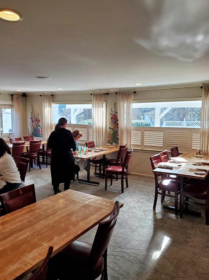 A dining room where natural light streams through windows, illuminating tables set for memorable meals and unhurried enjoyment.