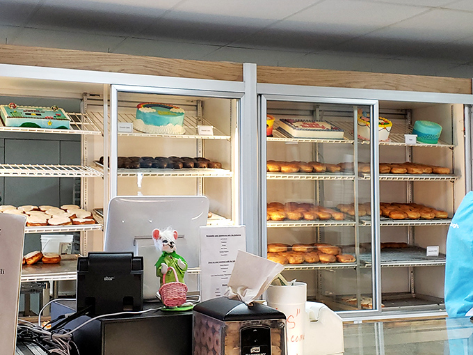 Fresh doughnuts awaiting their frosting destiny &ndash; the halfway point between raw ingredients and your inevitable breakfast bliss.