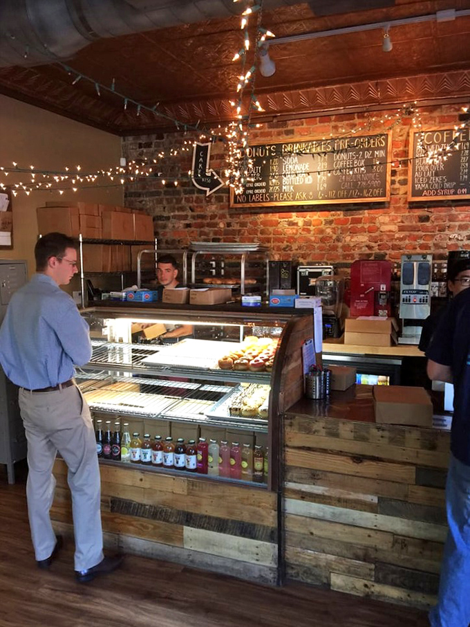Behind the counter, where donut magic happens. The display case showcases today's lineup like the jewelry counter at Tiffany's, but tastier.