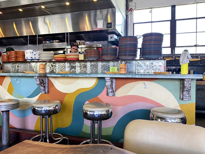 Behind the colorful counter, culinary magic happens. The whimsical waves painted below remind you this isn't your grandfather's greasy spoon&mdash;unless your grandfather was incredibly hip.