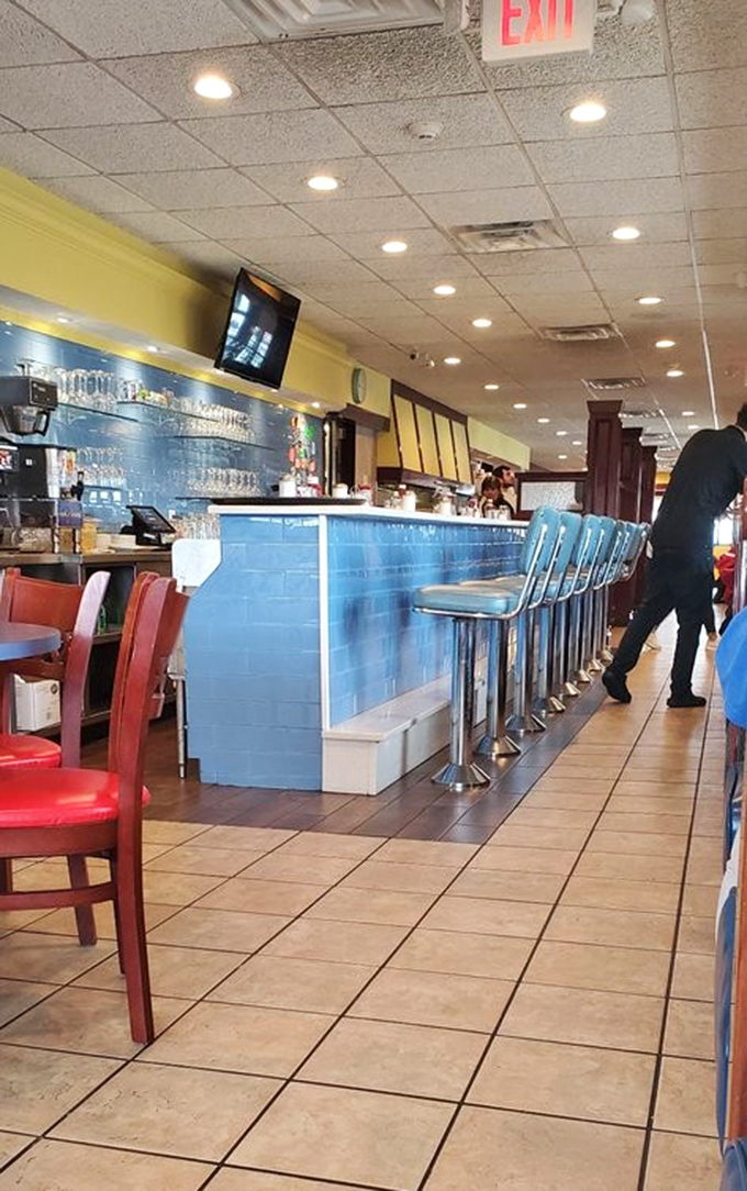 The counter where breakfast dreams come true and coffee cups never reach empty&mdash;a blue-tiled miracle of morning efficiency.