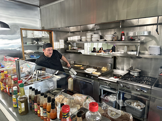 The wizard behind the breakfast curtain, wielding his spatula like Excalibur. This isn't cooking&mdash;it's performance art with eggs.
