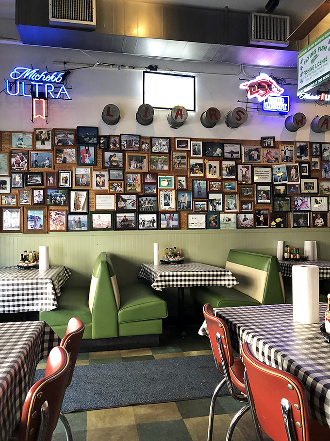 A wall of fishing memories tells stories without words. Each photo frame holds someone's "big catch" moment, preserved for posterity.