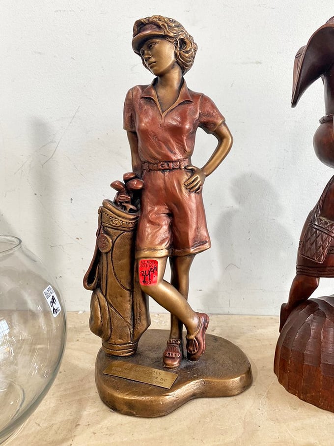 This bronze golfer stands ready to swing into action on your bookshelf. She's been waiting patiently for someone who appreciates both athletics and kitsch.