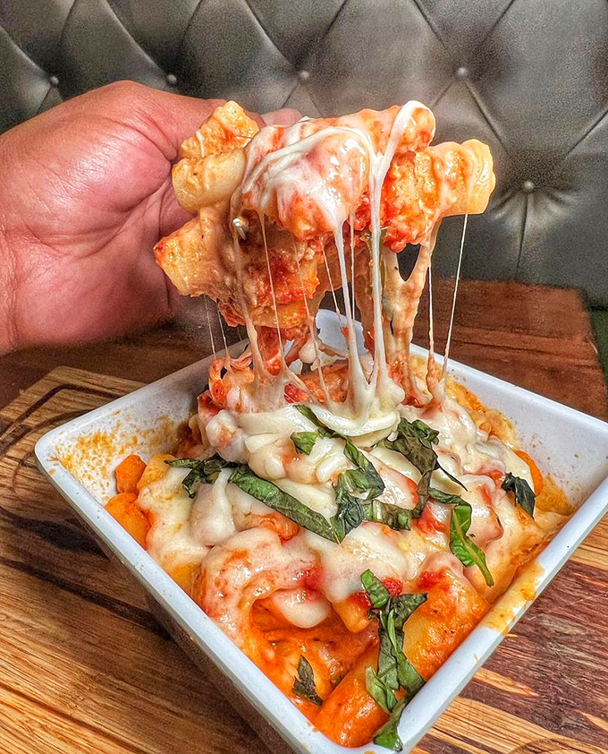 Baked ziti with a cheese pull that defies physics. Some people come for the sandwiches, but the pasta demands equal attention.