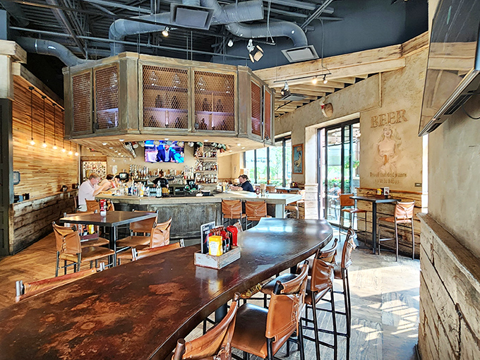 The bar area isn't just serving drinks&mdash;it's serving possibilities. That wood and metal aesthetic says "we take our burgers seriously, but not ourselves."