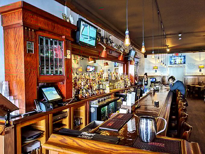 The bar at 317 Burger isn't just where drinks are served&mdash;it's command central for culinary happiness. Warm wood tones and amber lighting create instant comfort.