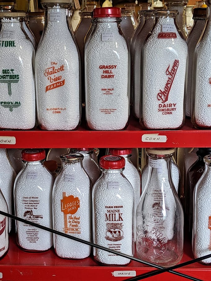 Discover these charming vintage milk bottles from local New England farms, lined up on bright red shelves waiting for you.