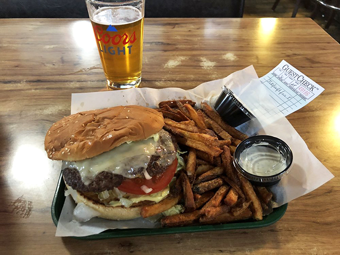 The complete experience: a juicy burger, hand-cut fries, and local beer—the holy trinity of tavern happiness.