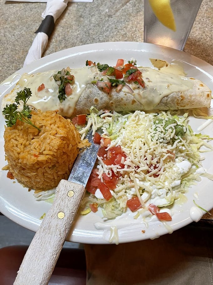 The Burrito Jalisco doesn't just sit on your plate&mdash;it commands attention with its blanket of queso and strategic placement of fresh pico de gallo.