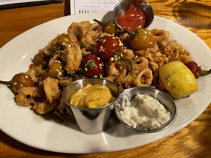 Crispy calamari mingles with colorful peppers in this playful starter that disappears faster than you can say "just one more piece."
