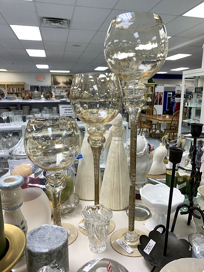 Towering glass candleholders stand like transparent sentinels among porcelain figurines, ready to cast a warm glow over your next dinner party. 