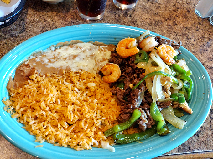 Carnitas sharing a plate with shrimp like old friends catching up – a surf and turf romance with Mexican flair.