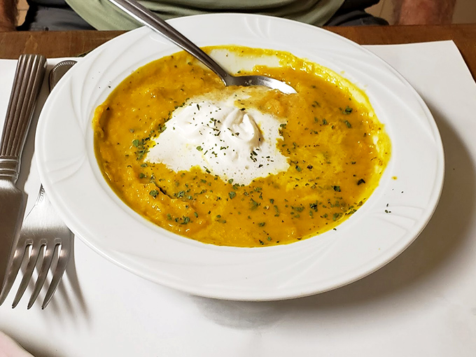 A bowl of sunshine disguised as carrot soup, complete with a cloud of sour cream. Comfort food that hugs you from the inside out.