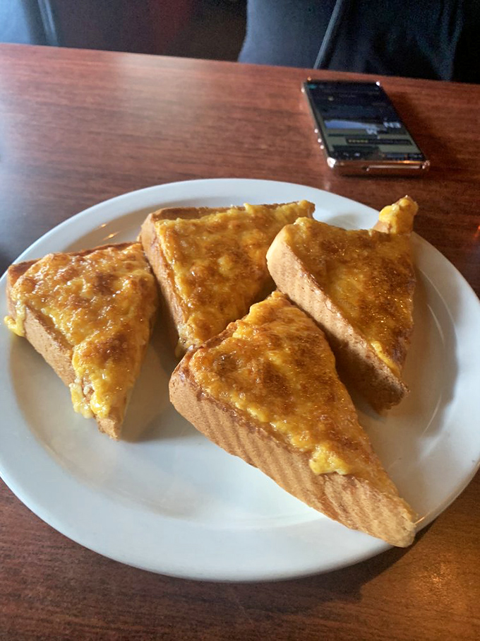 Triangles of cheese toast that would make the grilled cheese of your childhood weep with inadequacy. Simple pleasures, perfectly executed.