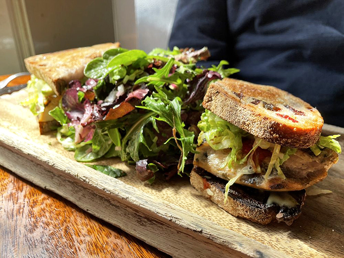 This sandwich isn't just lunch&mdash;it's structural engineering with flavor. Layers of goodness between perfectly toasted bread, with greens on the side pretending this is a balanced meal.