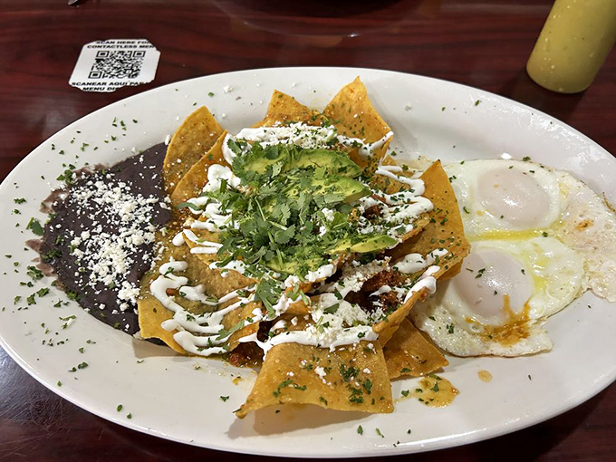 Chilaquiles: where tortilla chips go for their glorious afterlife, baptized in sauce and blessed with cheese and cilantro.