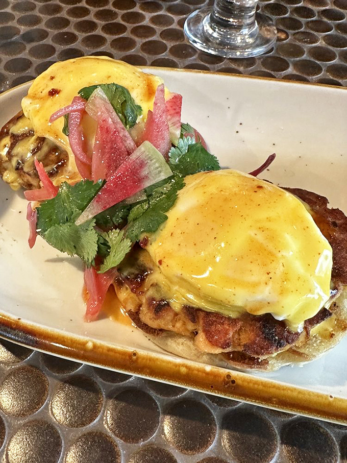 Benedict perfection: poached eggs perched atop salmon like golden-crowned royalty, with pickled radish adding the perfect acidic counterpoint.