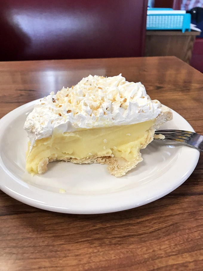 Coconut cream pie with a meringue hairdo that would make Dolly Parton proud. This slice isn't dessert&mdash;it's an event with a fork.