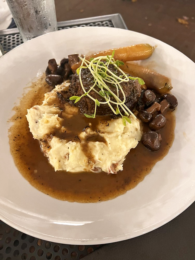 Short rib so tender it practically surrenders to your fork, nestled on a cloud of mashed potatoes. Comfort food with an advanced degree.