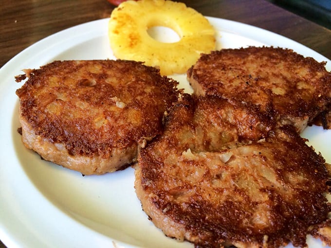 These golden-brown patties of corned beef hash with a pineapple ring aren't trying to impress food critics &ndash; they're busy making memories instead.