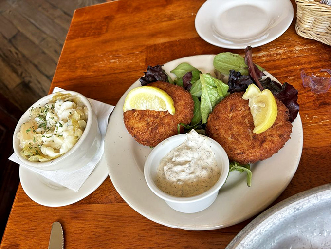 Golden-fried crab cakes that crackle with each fork touch, served with a side of mac and cheese that's having its own moment of glory.