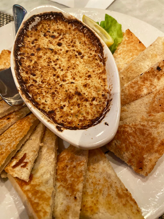 This bubbling crab dip looks like it's auditioning for a food magazine cover&mdash;golden-topped and surrounded by its crispy toast entourage.