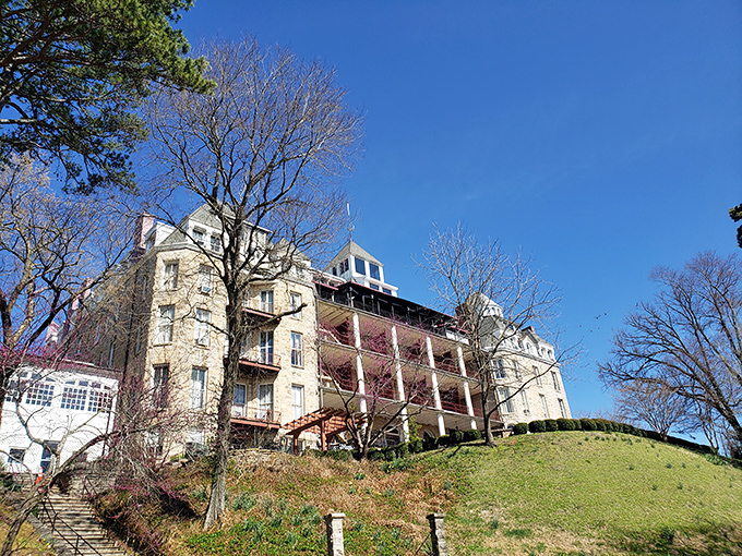 The historic Crescent Hotel perches majestically on its hillside throne, its limestone walls holding secrets of Eureka Springs' colorful past.