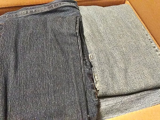 Folded denim tells tales of previous lives. These jeans have stories woven into their fibers, waiting for new chapters to begin.