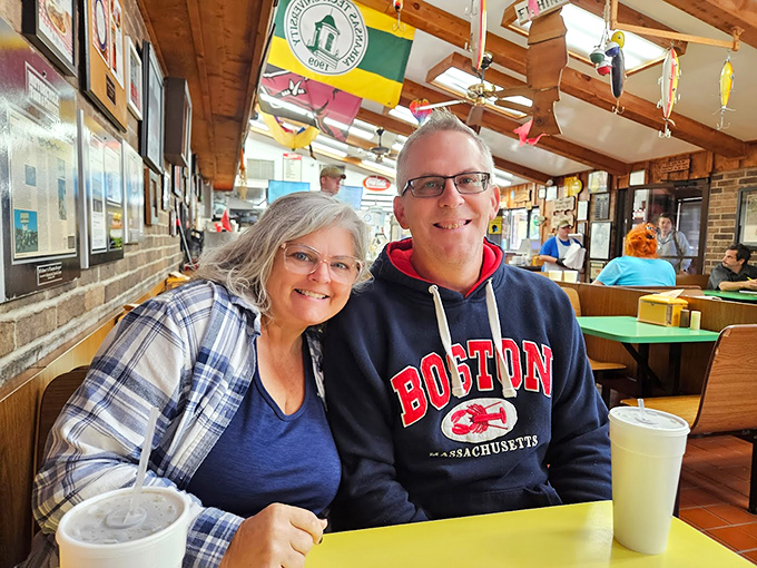 Happy diners sharing a moment over milkshakes&mdash;the universal language of good food bringing people together since forever.