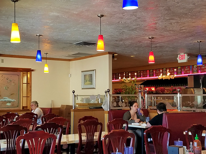 Diners enjoy the comfortable ambiance, where colorful pendant lights and conversation flow as freely as the refills.
