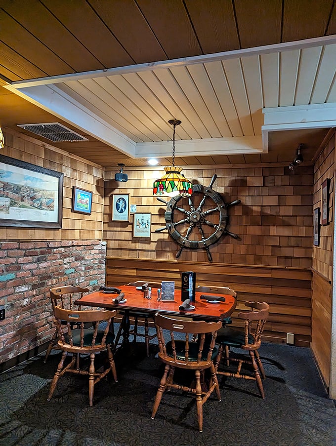 Nautical meets rustic in this dining nook where a ship's wheel stands guard, silently answering the eternal question: "Who's steering this meal?"